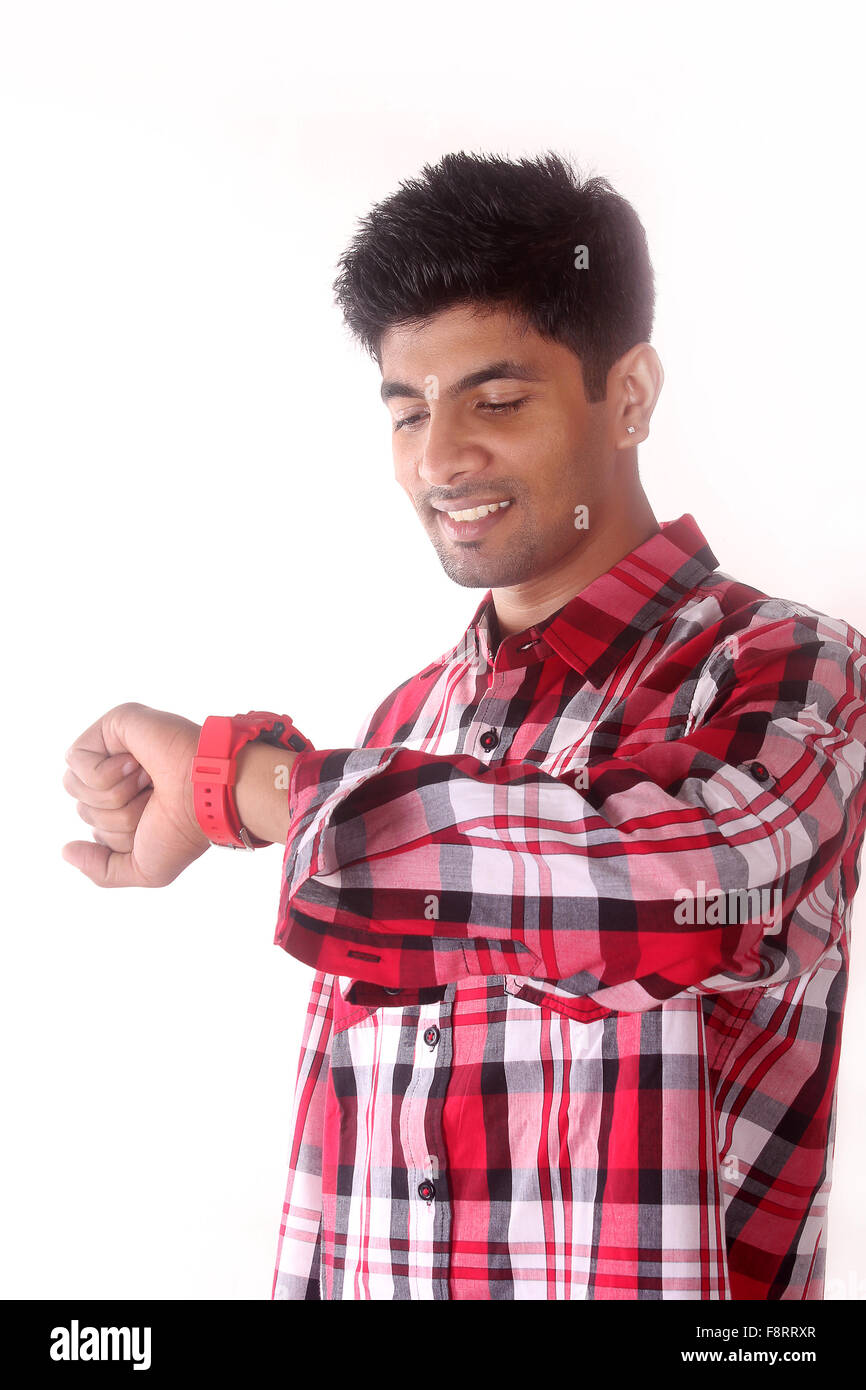 Confident good looking young guy looking at his watch on Stock Photo ...