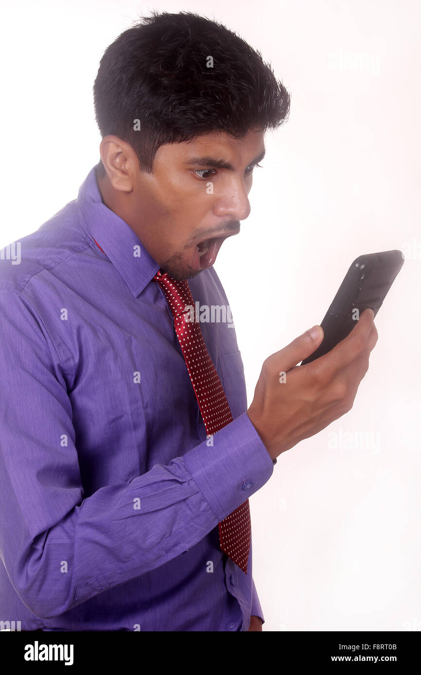 Angry business man screaming on cell mobile phone, portrait of young ...