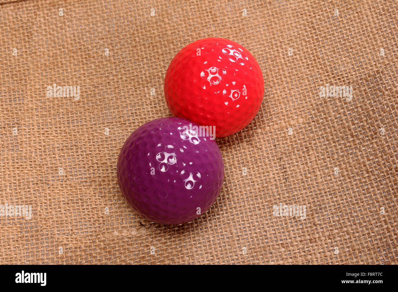 Golf ball -Red golf ball & violet in the green grass,Golf ball Stock ...