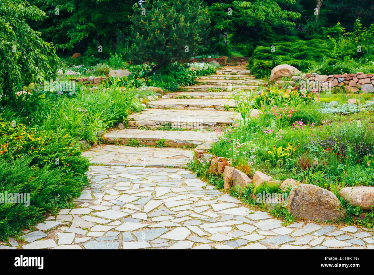 Stone Pathway Walkway Lane Path With Green Trees And Bushes In Garden ...