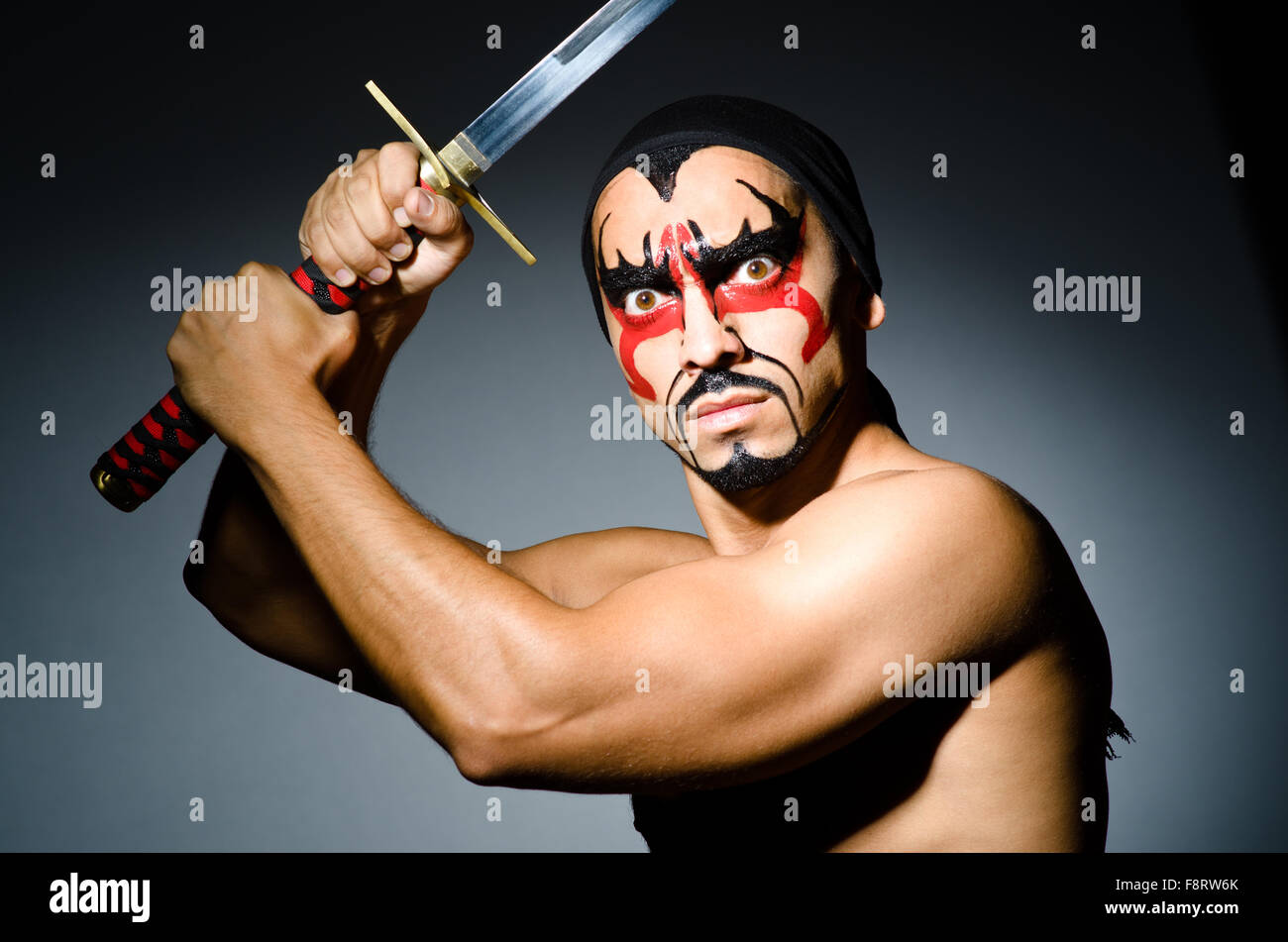 Man with sword and face paint Stock Photo - Alamy