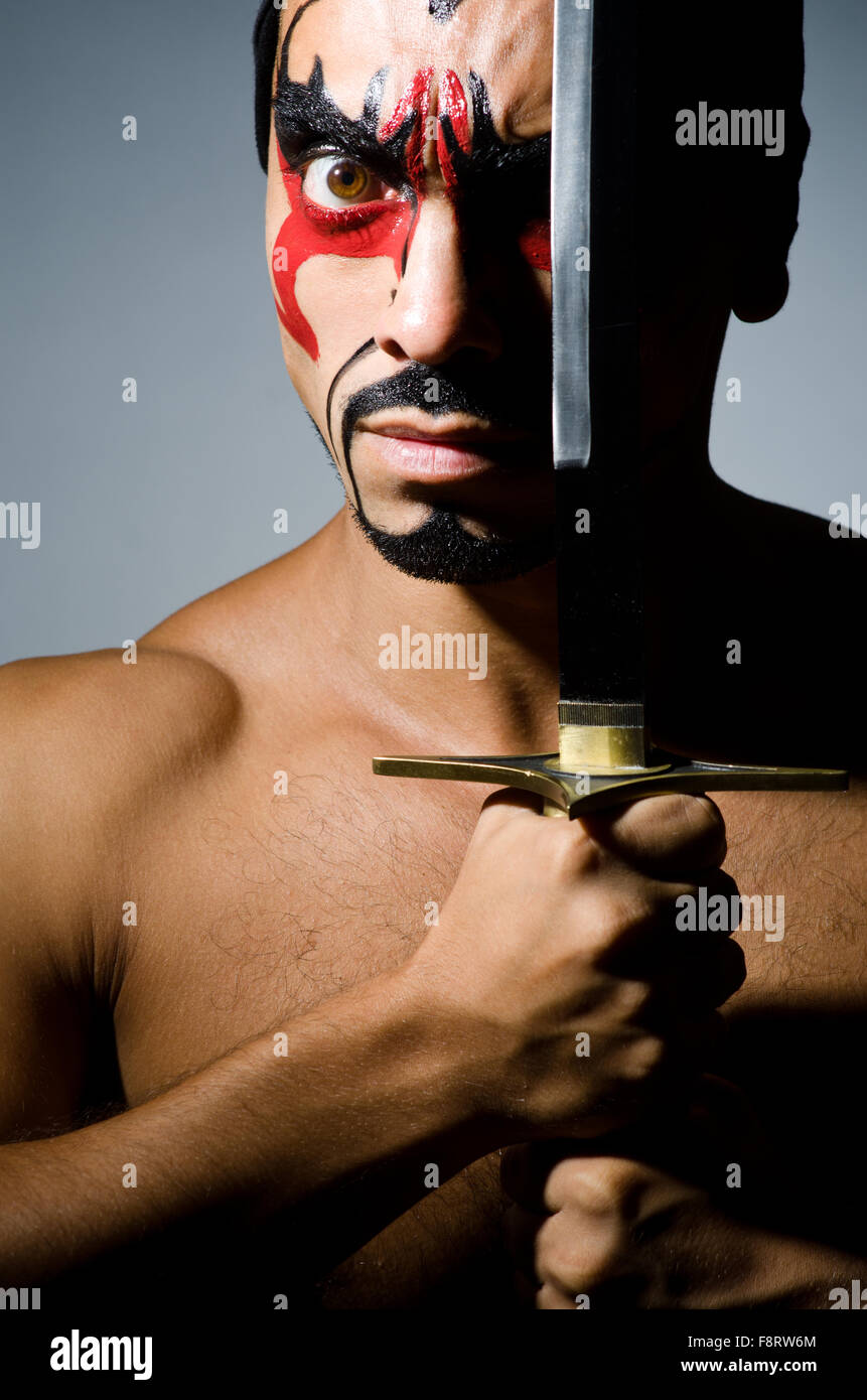 Man with sword and face paint Stock Photo - Alamy