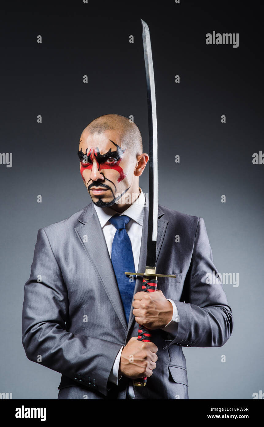Man with face paint and sword Stock Photo - Alamy