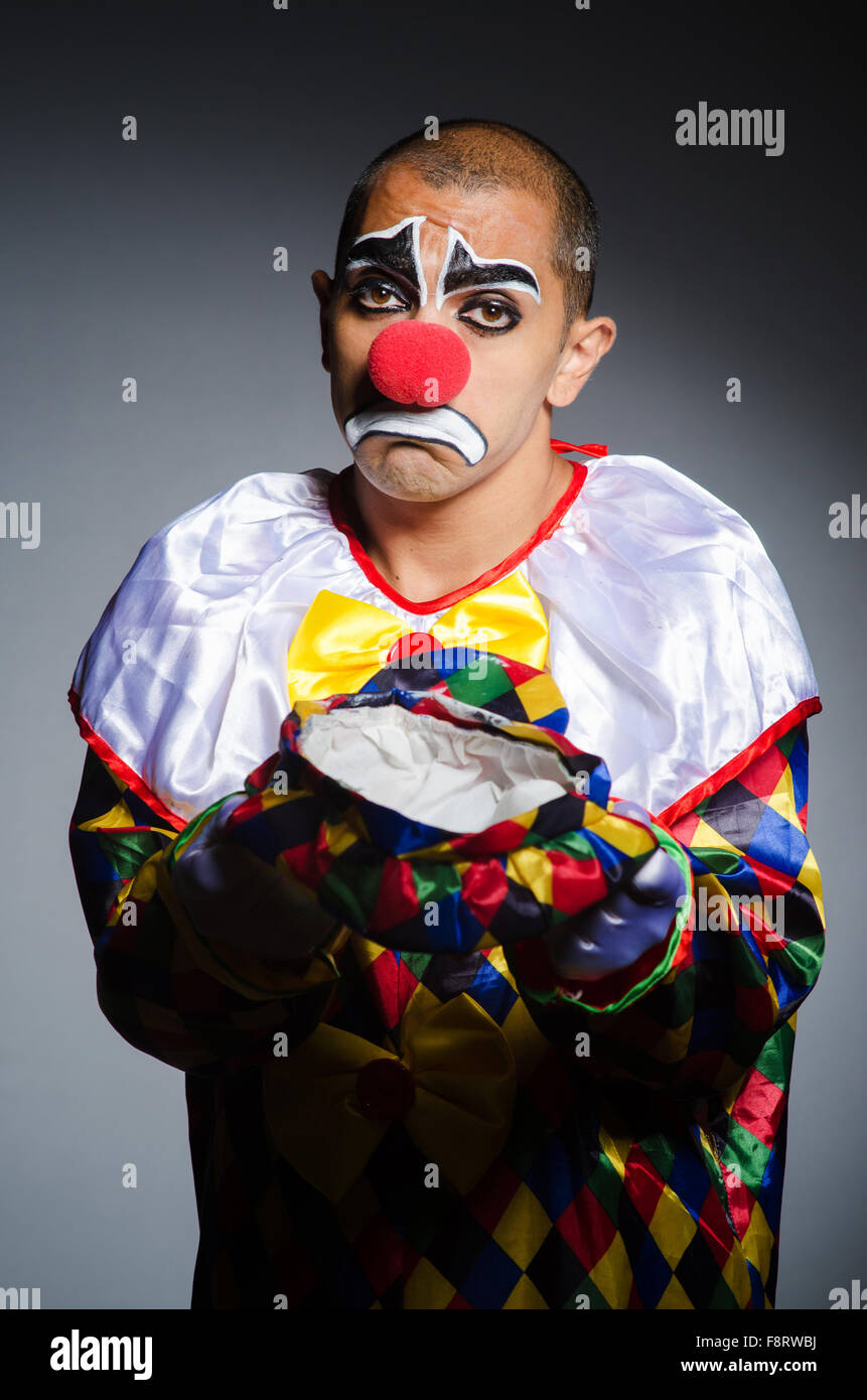 Sad clown against dark background Stock Photo - Alamy