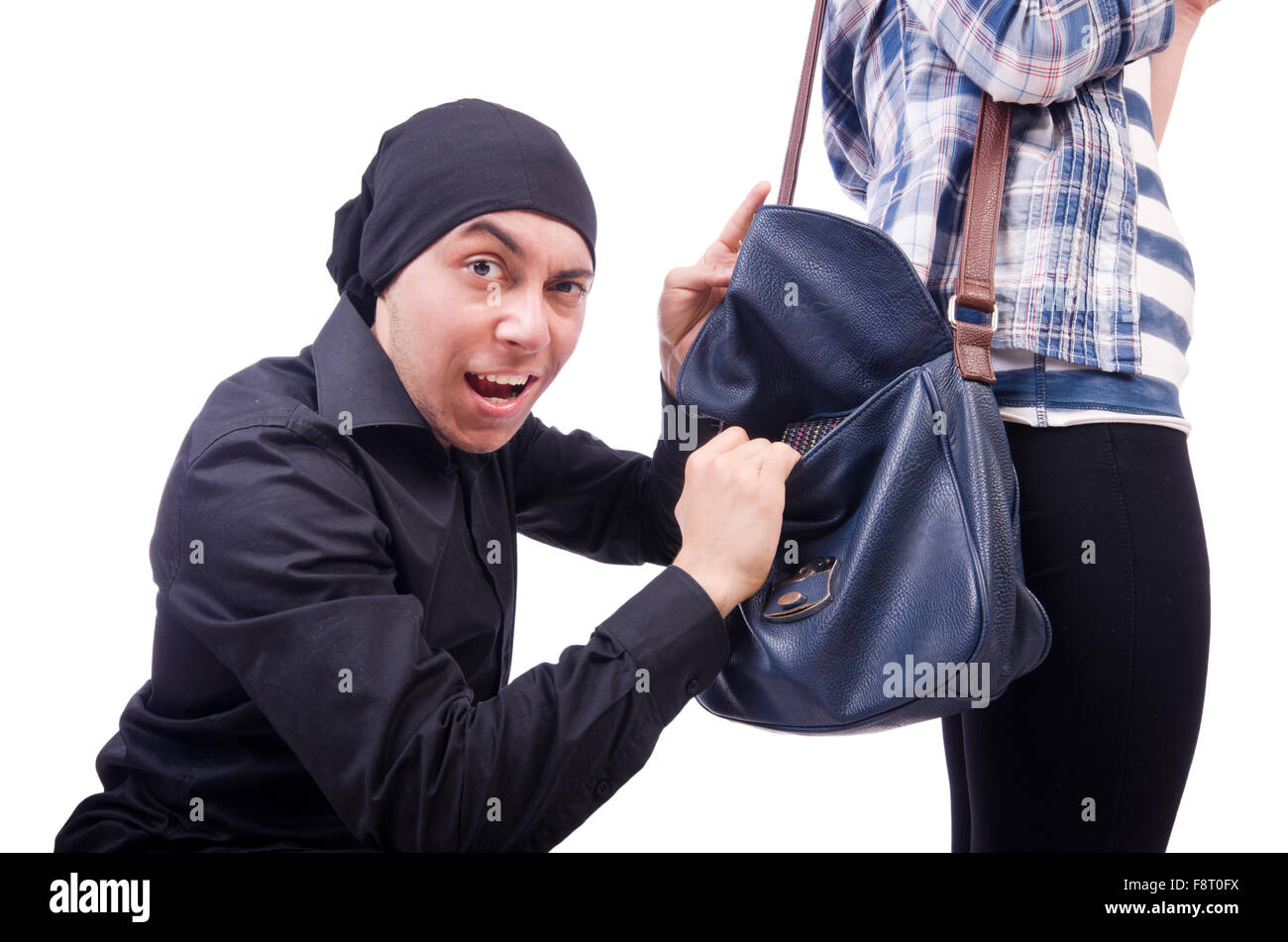 Young thief stealing woman's bag Stock Photo - Alamy