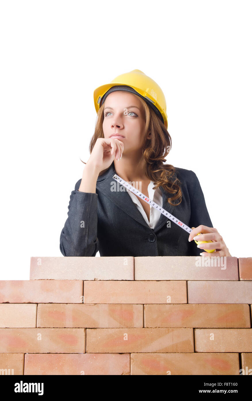 Woman builder measuring isolated on the white Stock Photo - Alamy