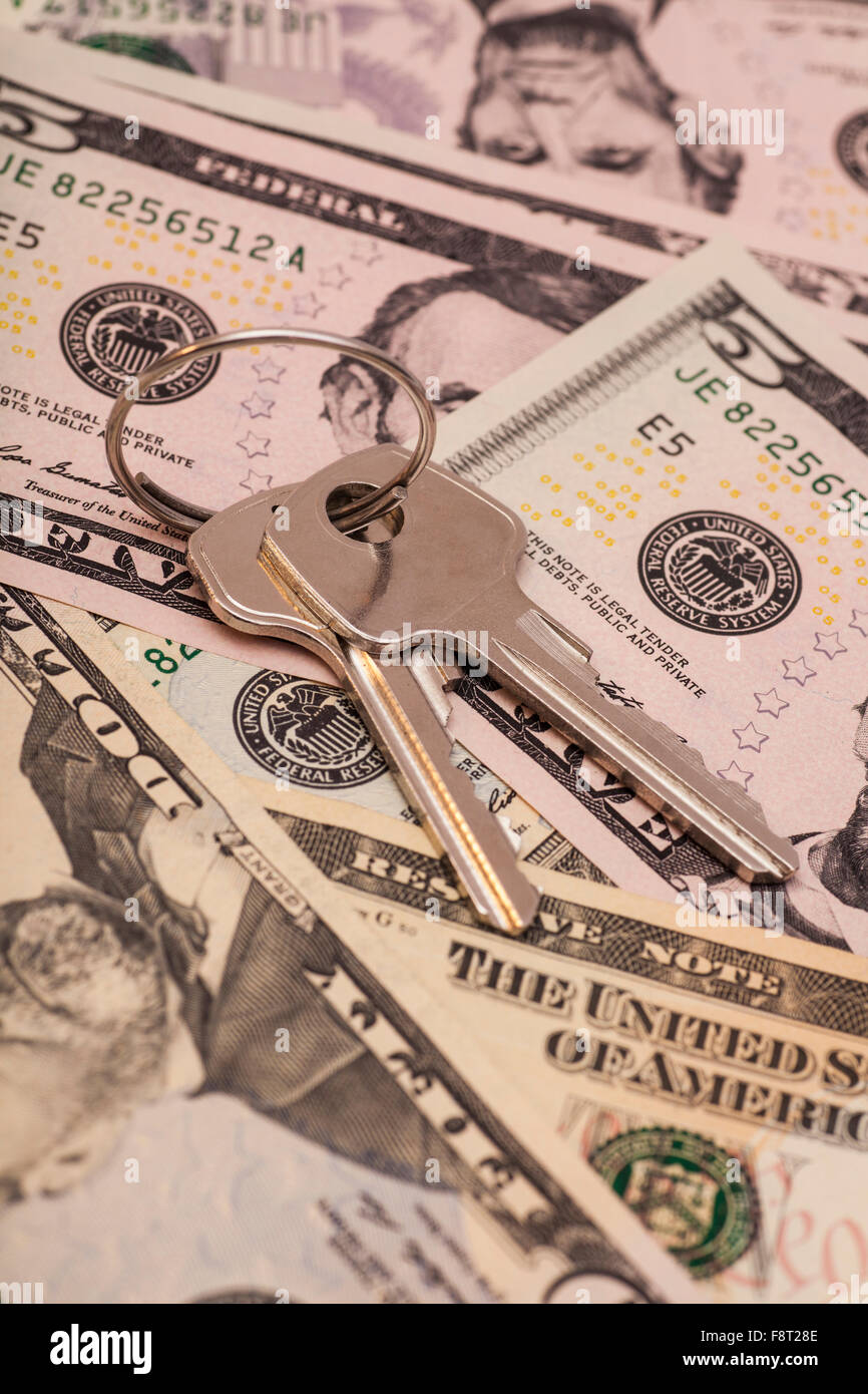 Key on dollar bills isolated on white Stock Photo - Alamy