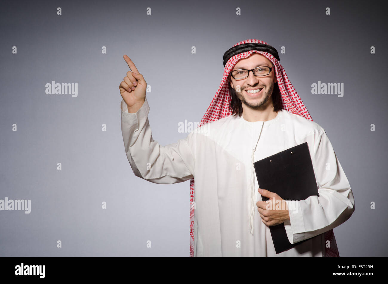 Arab man with paper binder Stock Photo - Alamy