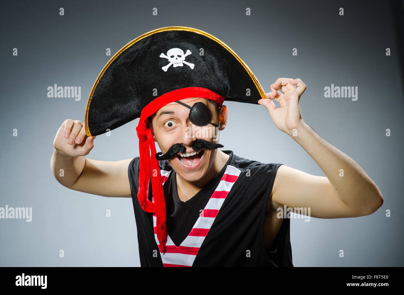 Funny pirate in the dark studio Stock Photo - Alamy