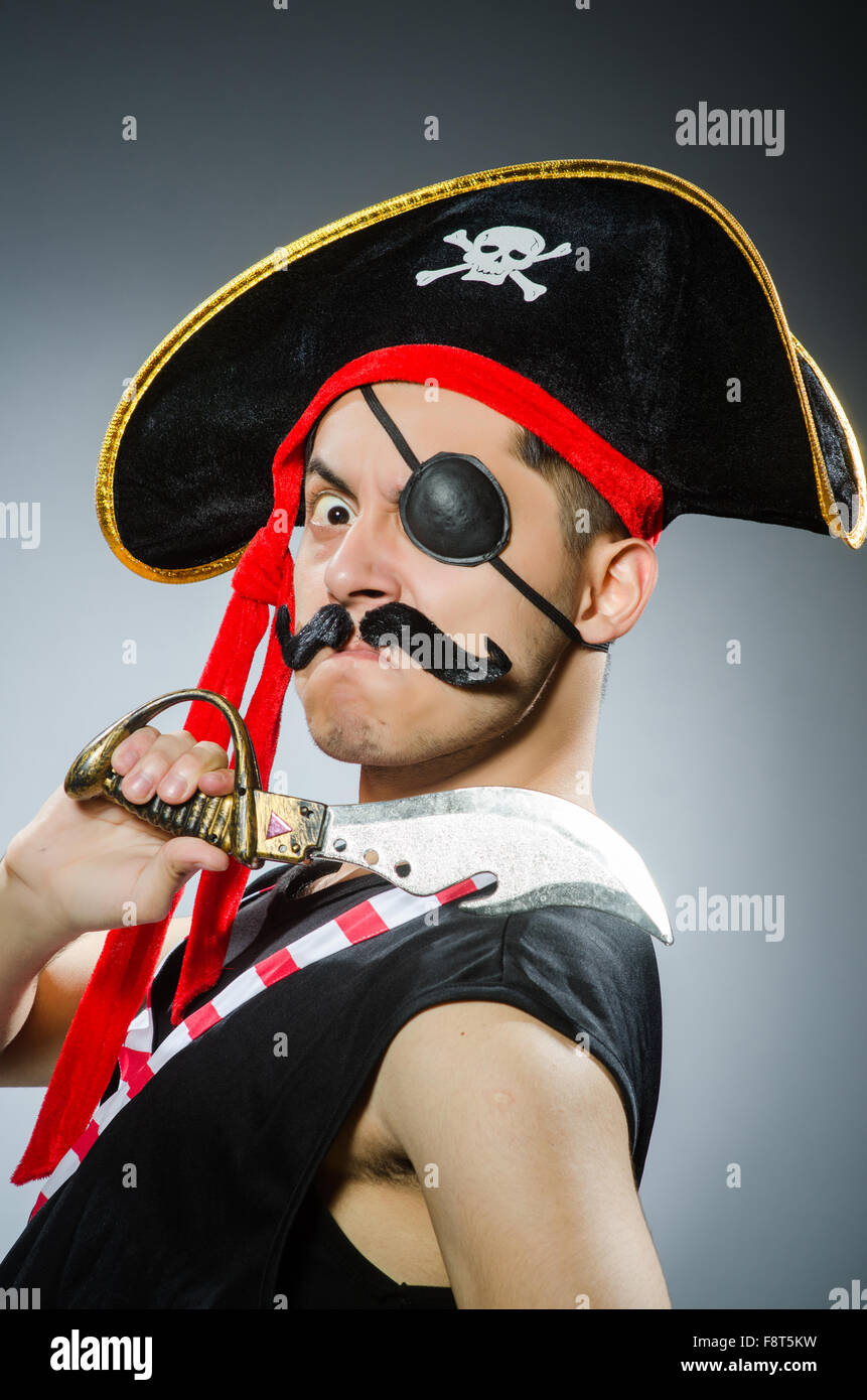 Funny pirate in the dark studio Stock Photo - Alamy