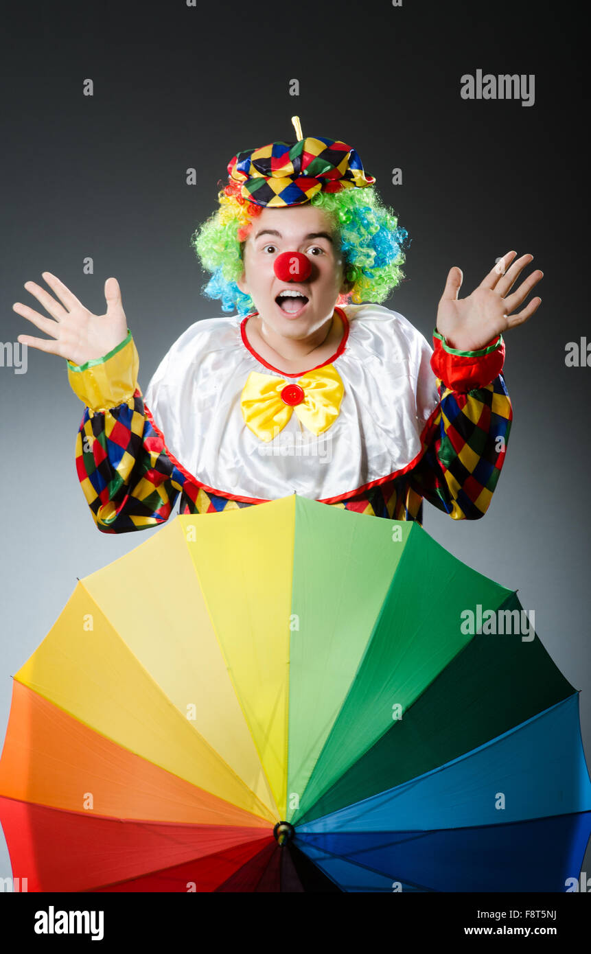 Funny clown with colourful umbrella Stock Photo - Alamy