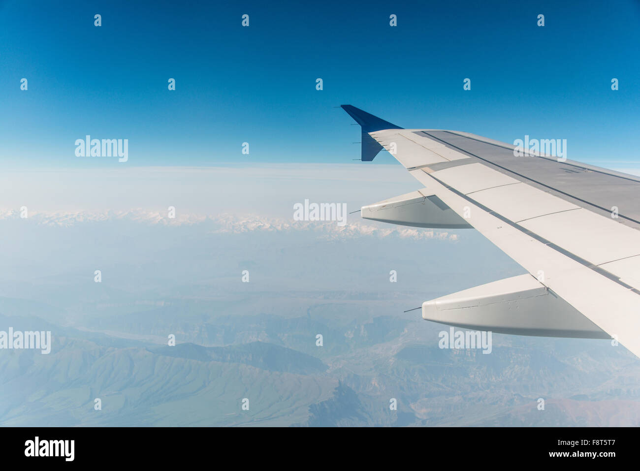 Airplane wing out of window Stock Photo - Alamy