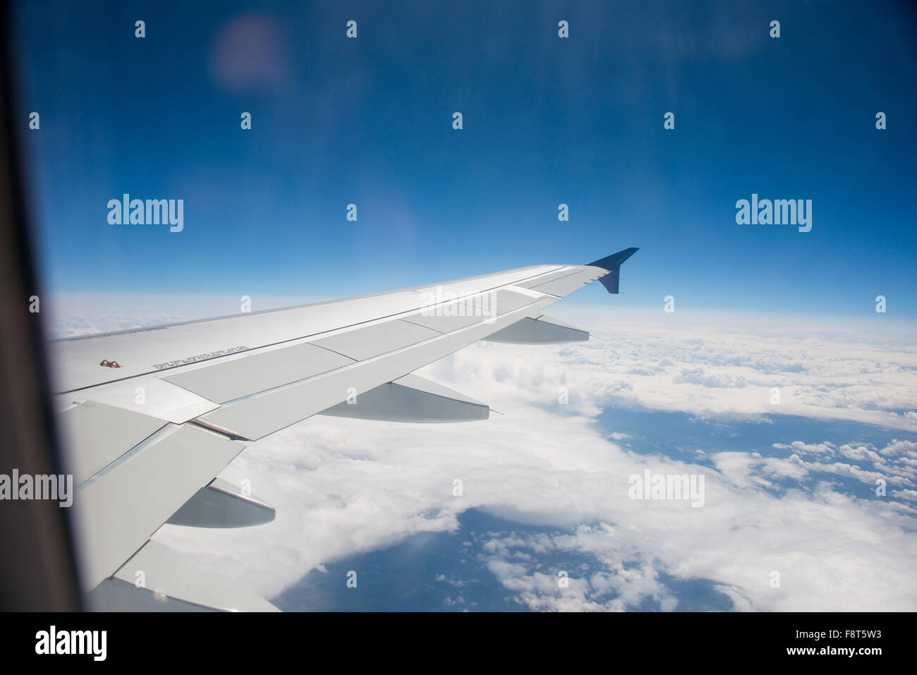 Airplane wing out of window Stock Photo - Alamy
