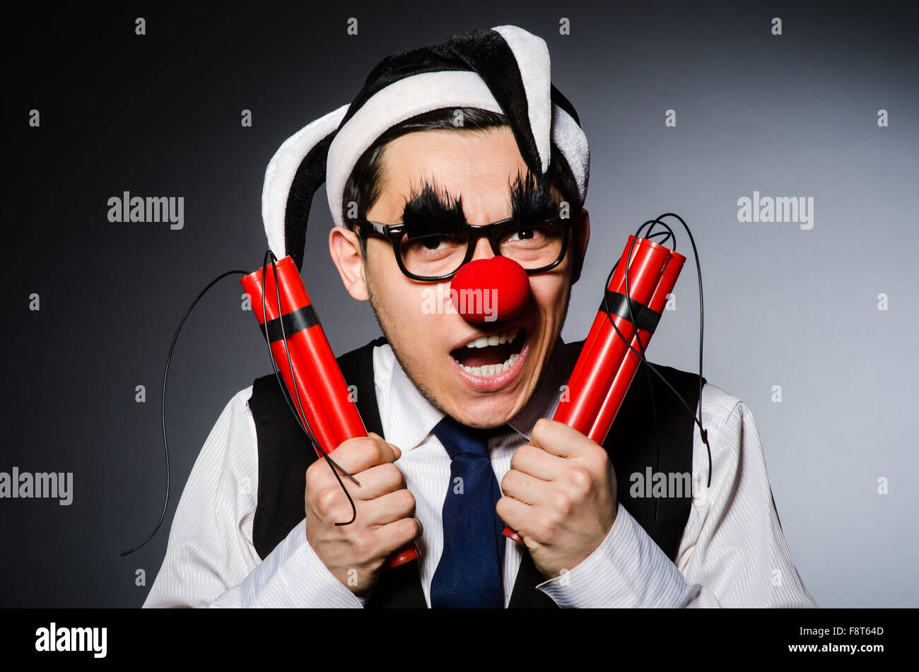 Funny clown with sticks of dynamite Stock Photo - Alamy