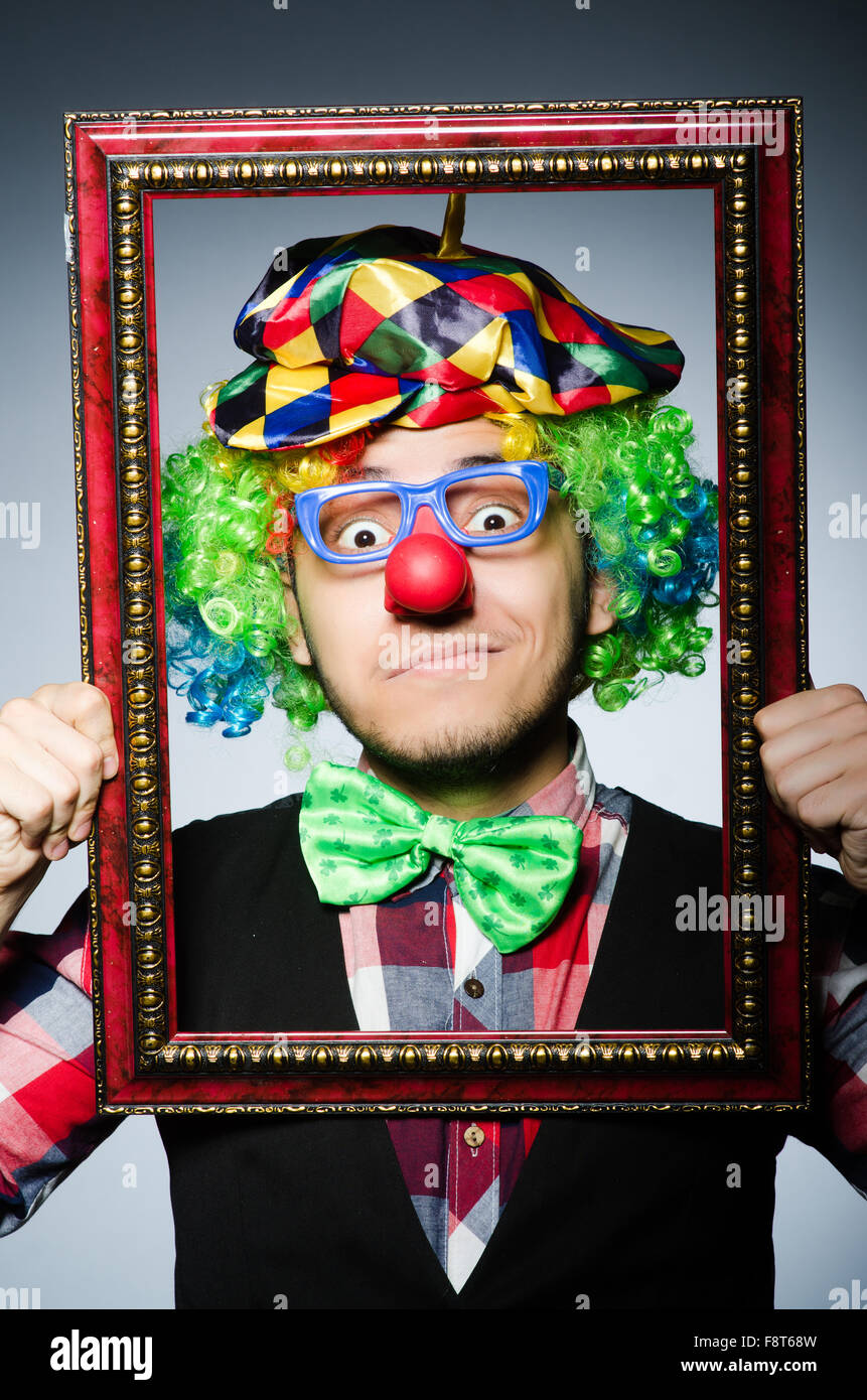 Funny clown with picture frame Stock Photo - Alamy