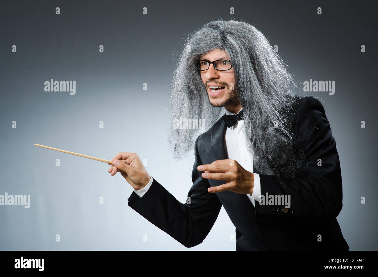 Funny conductor with long grey hair Stock Photo - Alamy