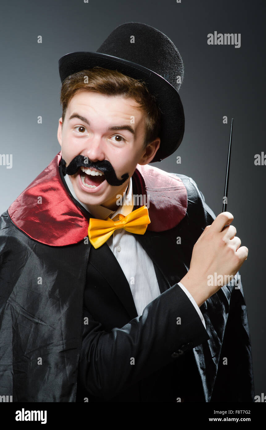 Funny magician with wand and hat Stock Photo - Alamy