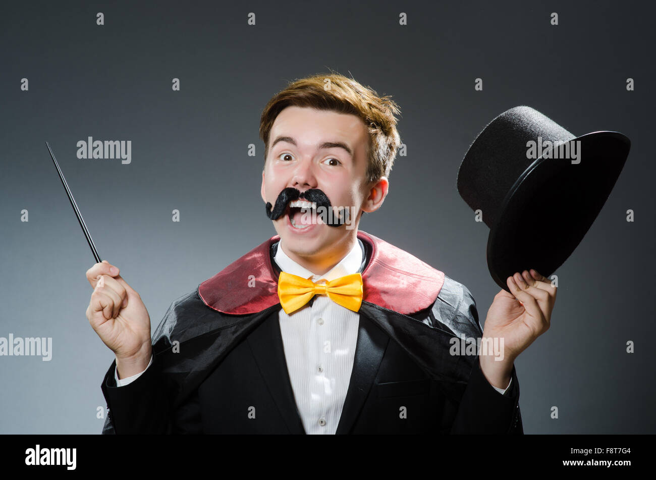 Funny magician with wand and hat Stock Photo - Alamy