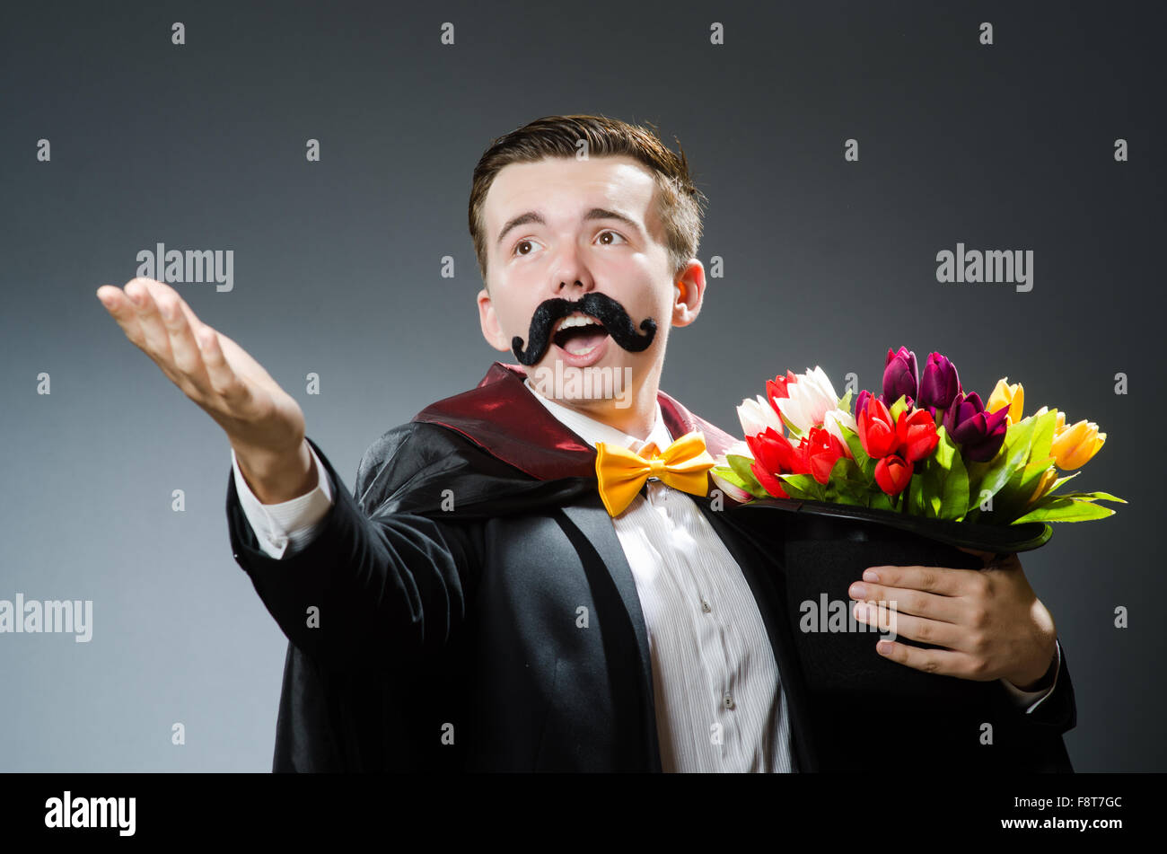 Funny magician with wand and hat Stock Photo - Alamy