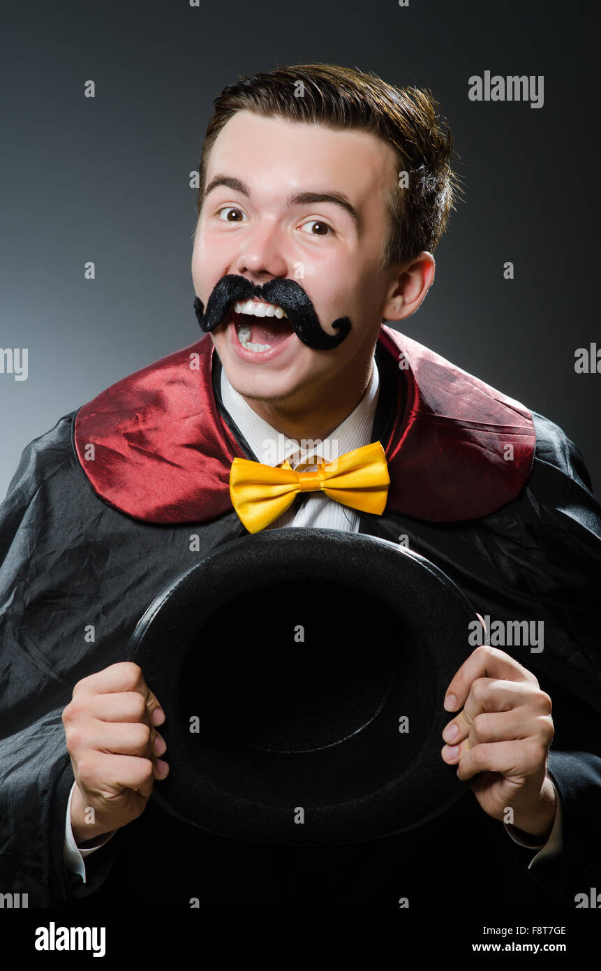 Funny magician with wand and hat Stock Photo - Alamy