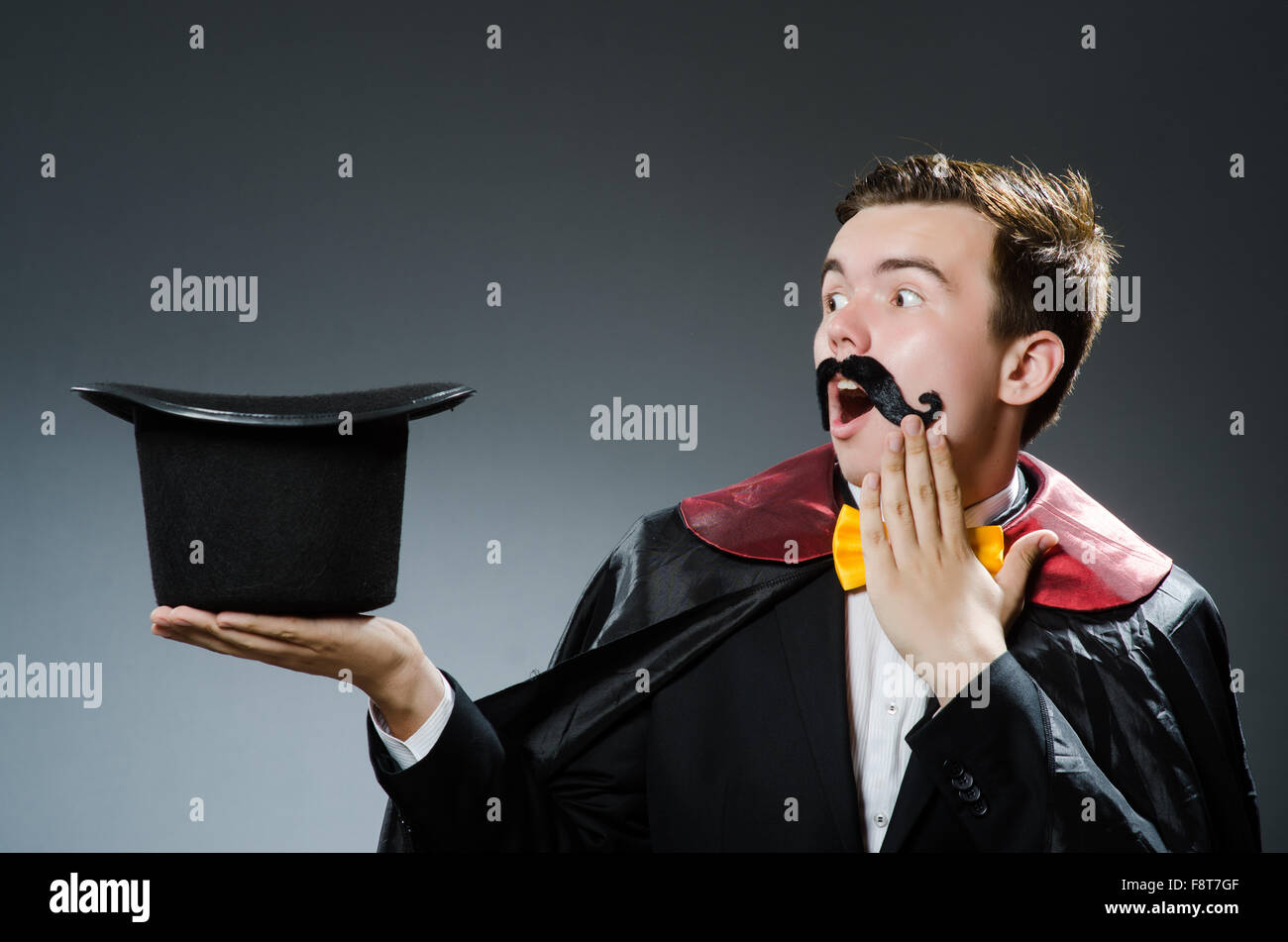 Funny magician with wand and hat Stock Photo - Alamy