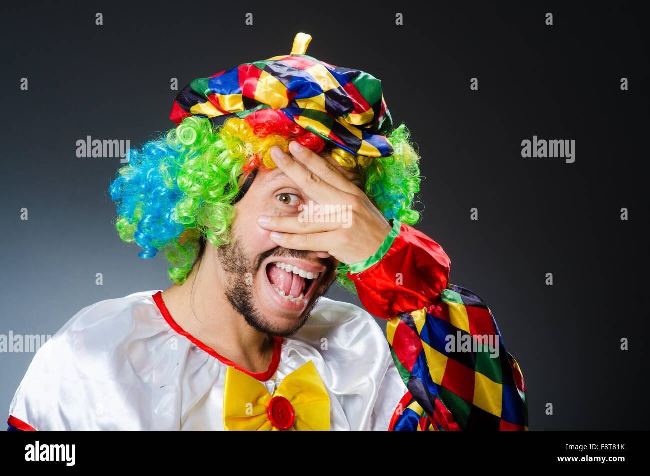 Funny clown in colourful costume Stock Photo - Alamy