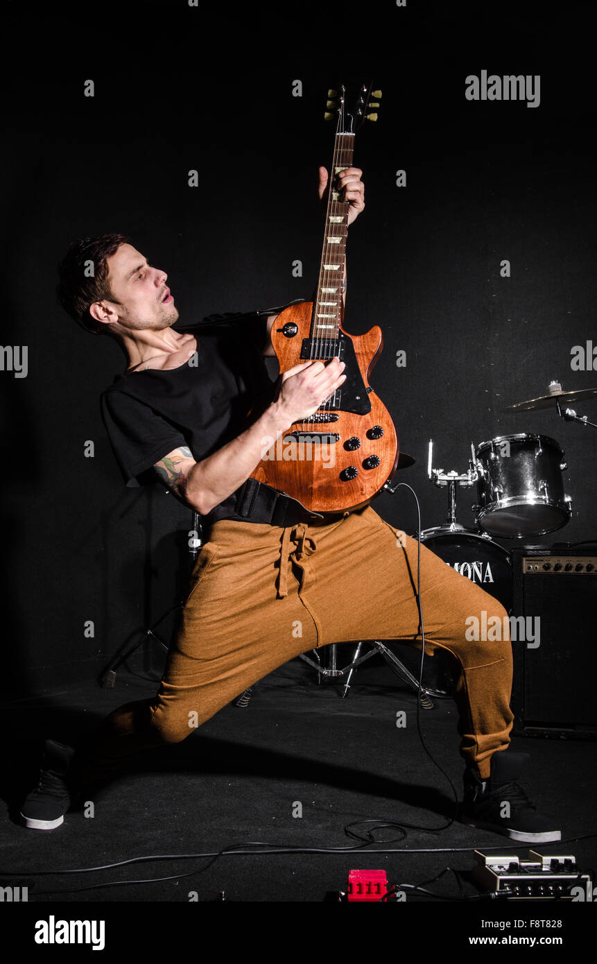 Man with guitar during concert Stock Photo - Alamy