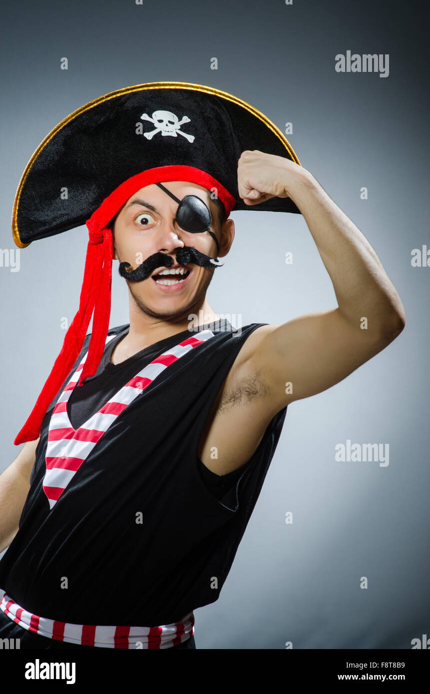 Funny pirate in the dark studio Stock Photo - Alamy