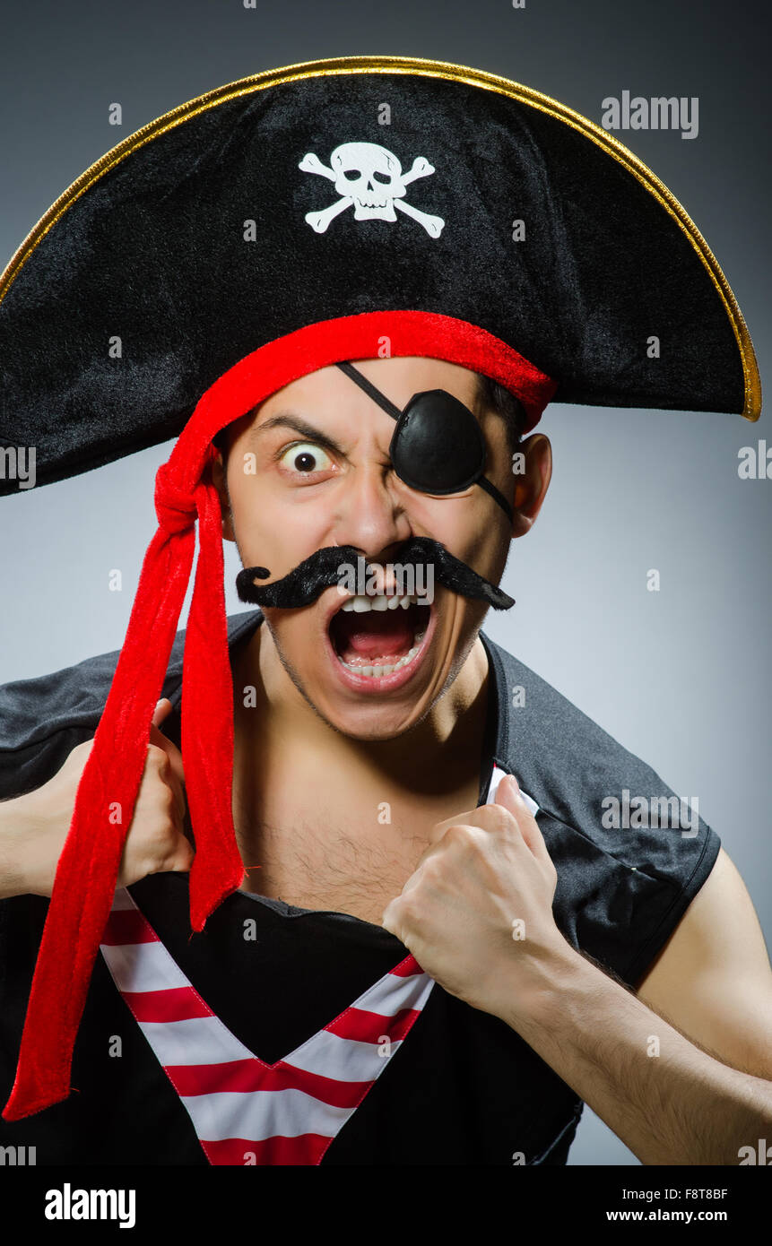 Funny pirate in the dark studio Stock Photo - Alamy