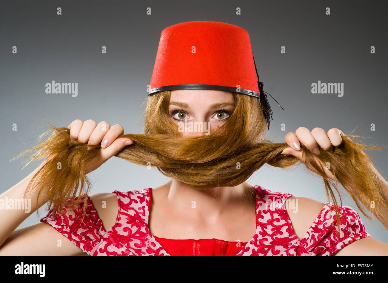 Woman wearing red fez hat Stock Photo - Alamy