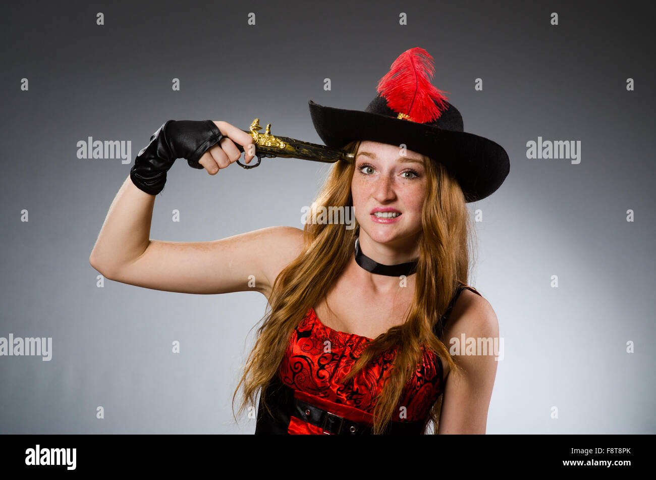 Pirate with gun against grey background Stock Photo - Alamy