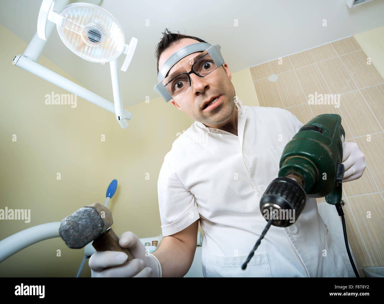 crazy dentist ready to drill approached the patient and dental ...