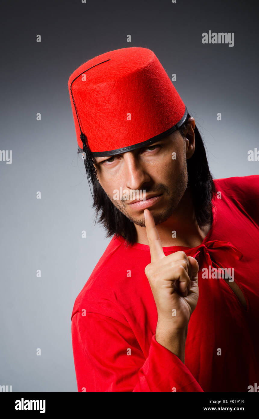 Man in red dress wearing fez hat Stock Photo - Alamy
