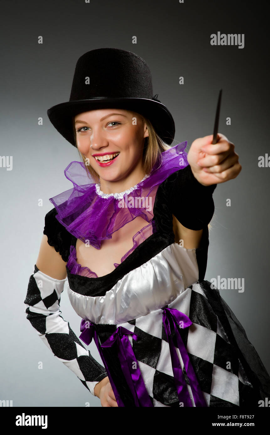 Woman magician doing her tricks with wand Stock Photo - Alamy
