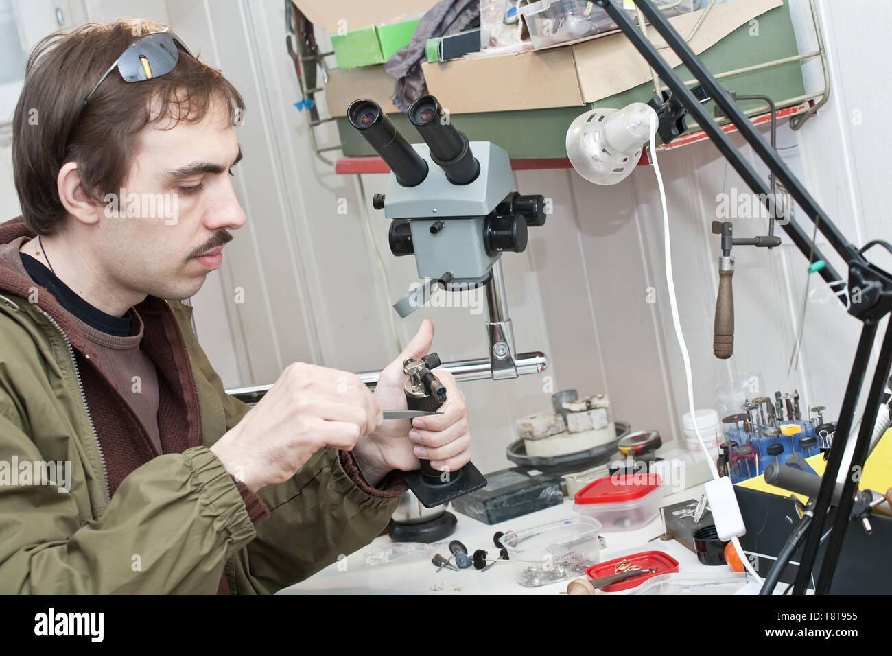 Male jeweller is working at jeweller's workshop Stock Photo - Alamy