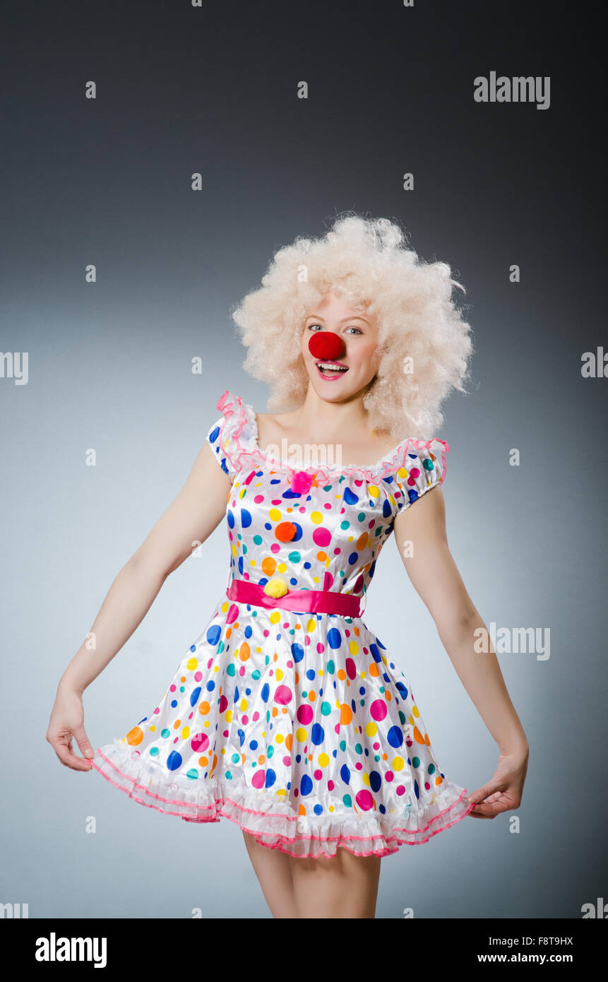 Clown with white wig against grey background Stock Photo - Alamy