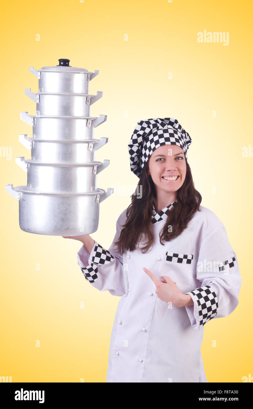 Cook with stack of pots on white Stock Photo - Alamy
