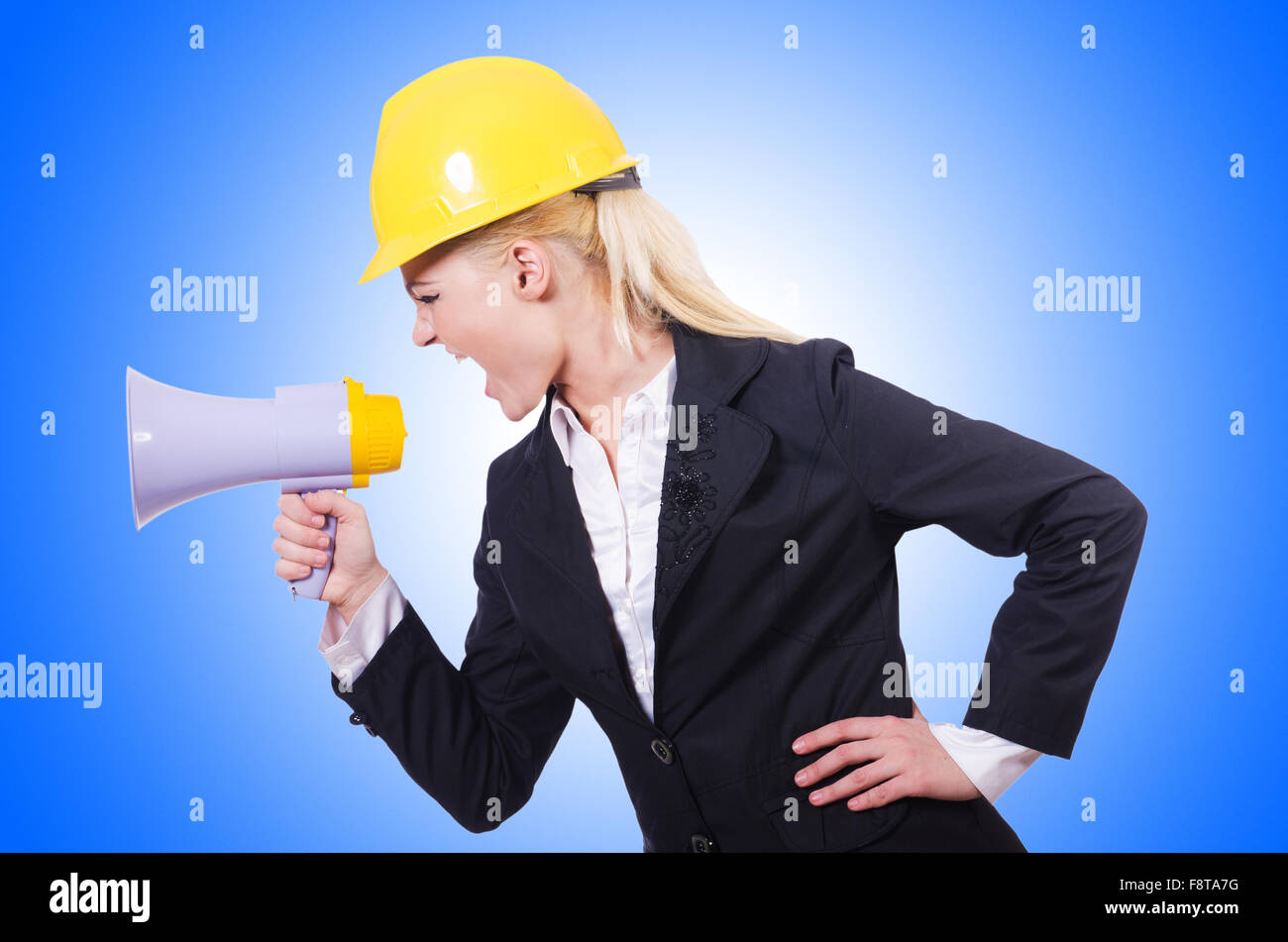 Female construction worker with loudspeaker Stock Photo - Alamy