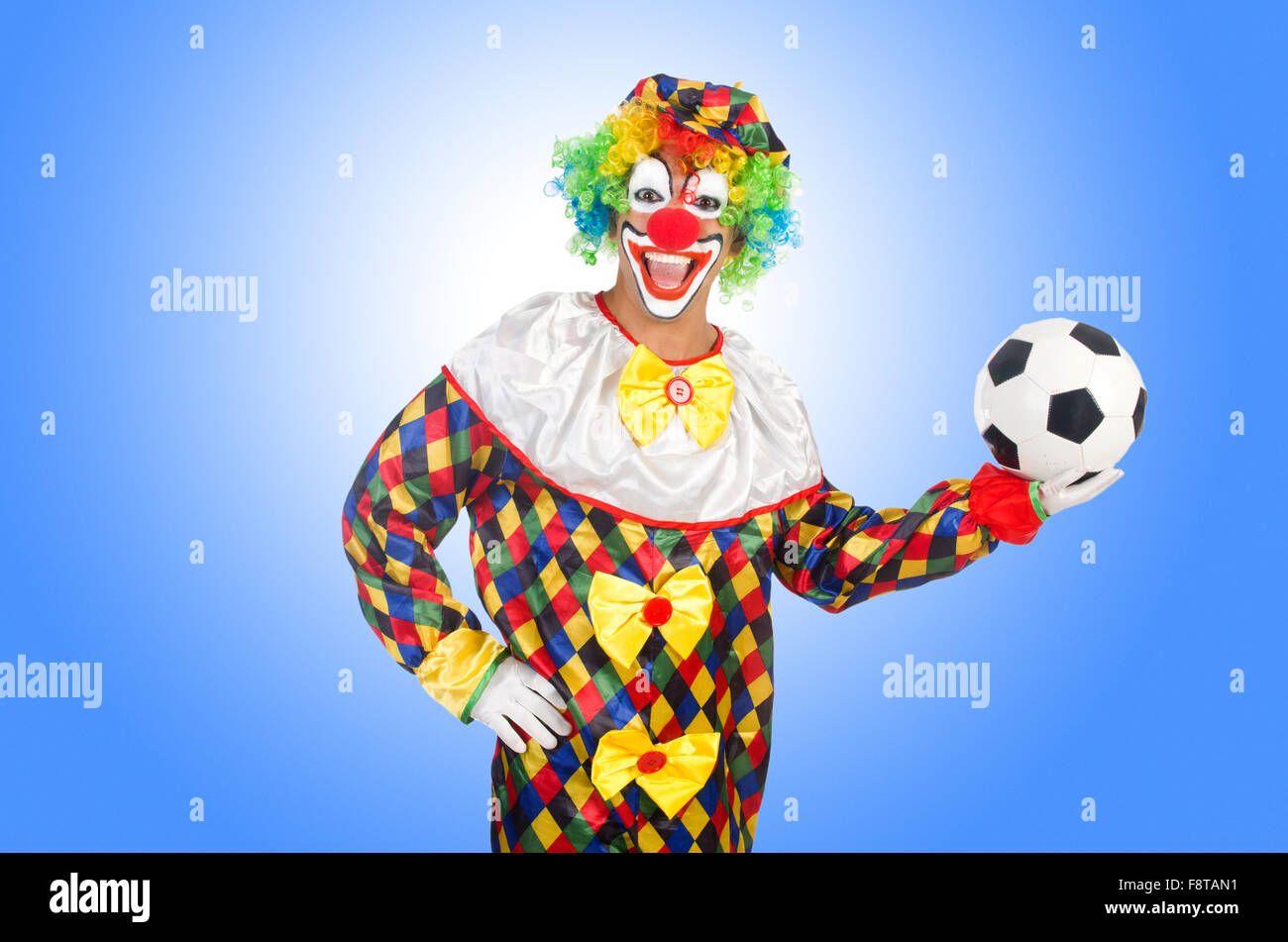 Clown with football ball on white Stock Photo - Alamy