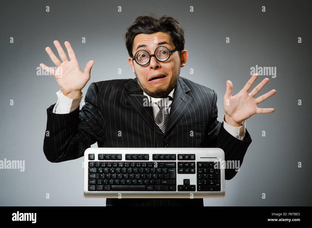 Comouter geek with computer keyboard Stock Photo - Alamy