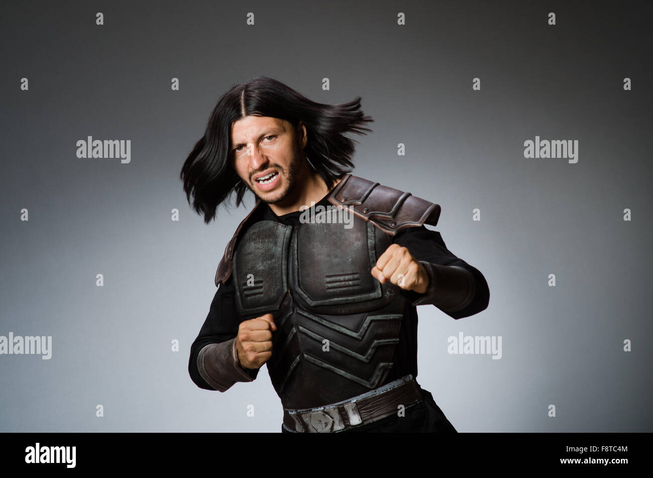 Angry warrior against dark background Stock Photo - Alamy