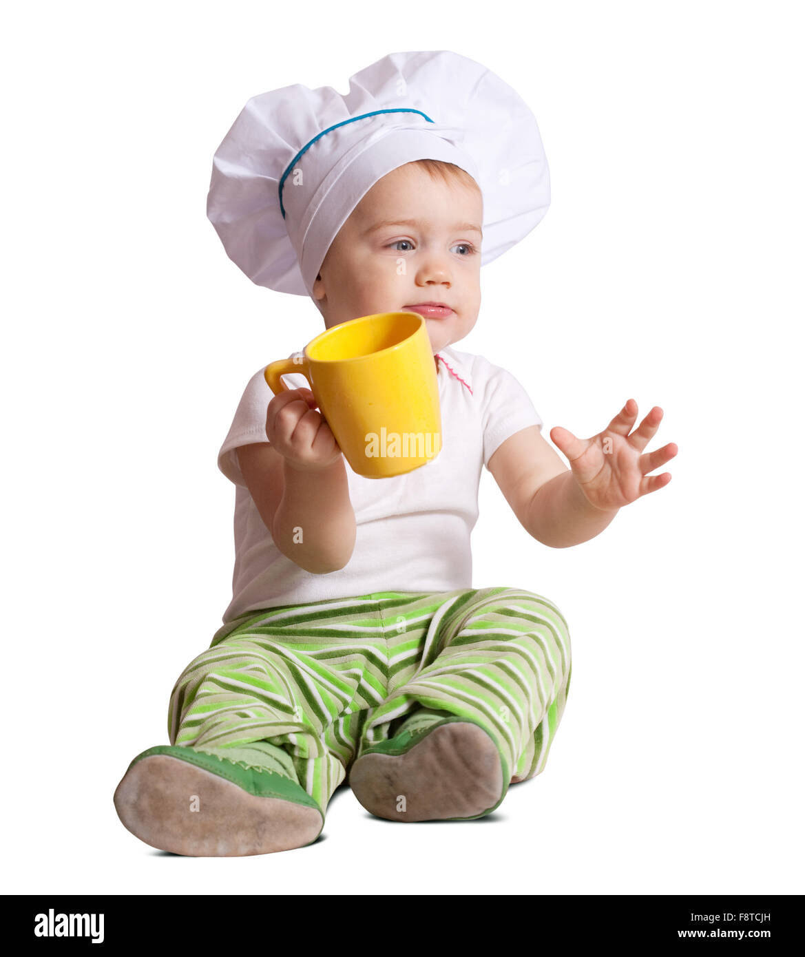 Baby cook in toque with cup over white background Stock Photo - Alamy