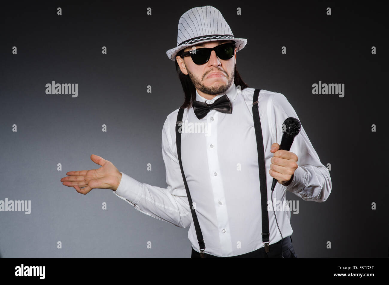 Funny singer with microphone at the concert Stock Photo - Alamy