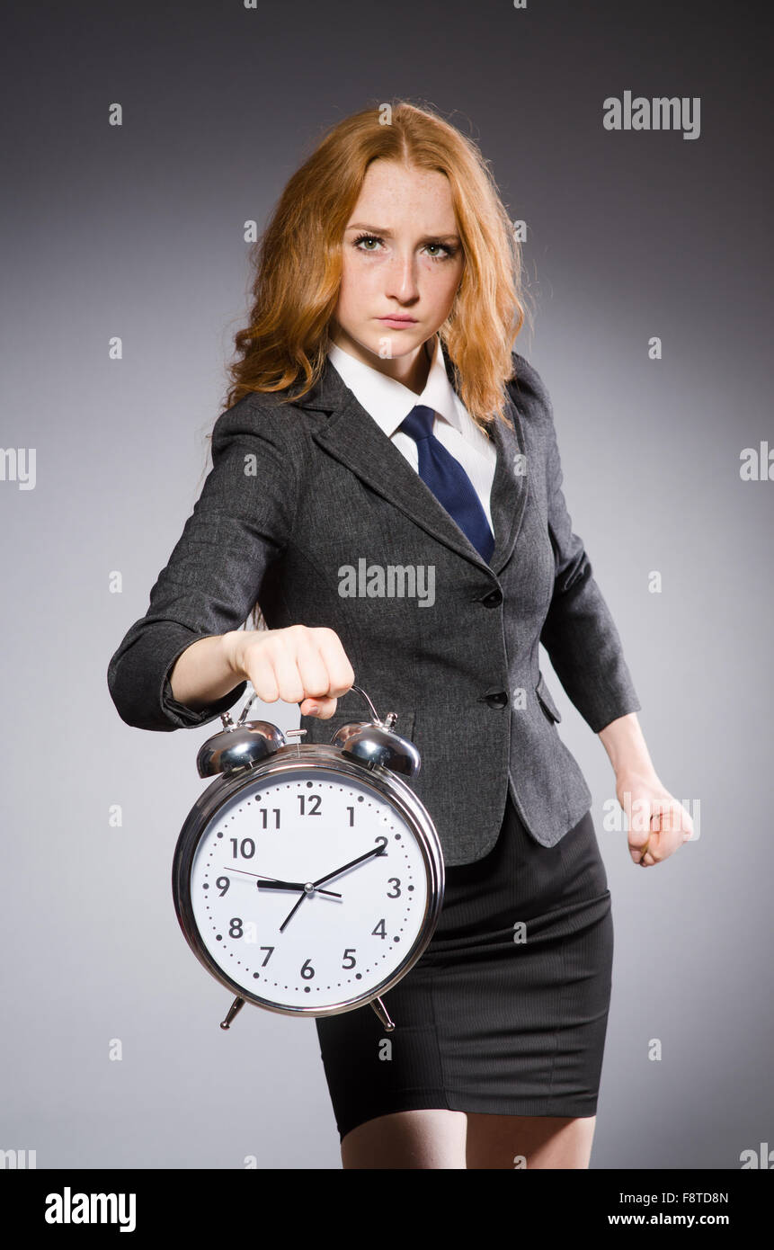 Businesswoman with clock being late for her deliverables Stock Photo ...