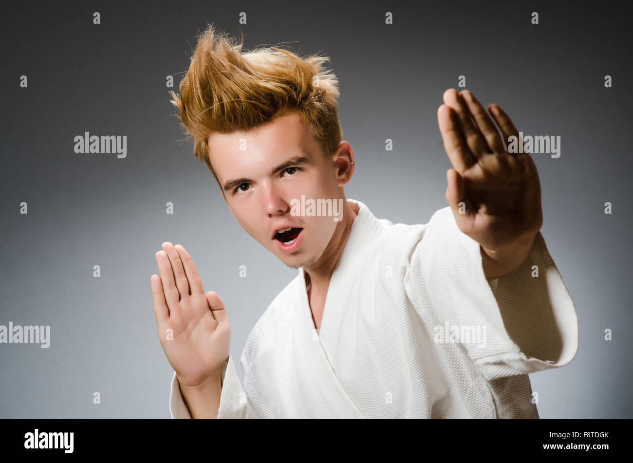 Funny karate fighter wearing white kimono Stock Photo - Alamy