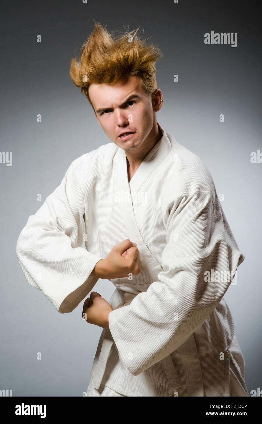 Funny karate fighter wearing white kimono Stock Photo - Alamy