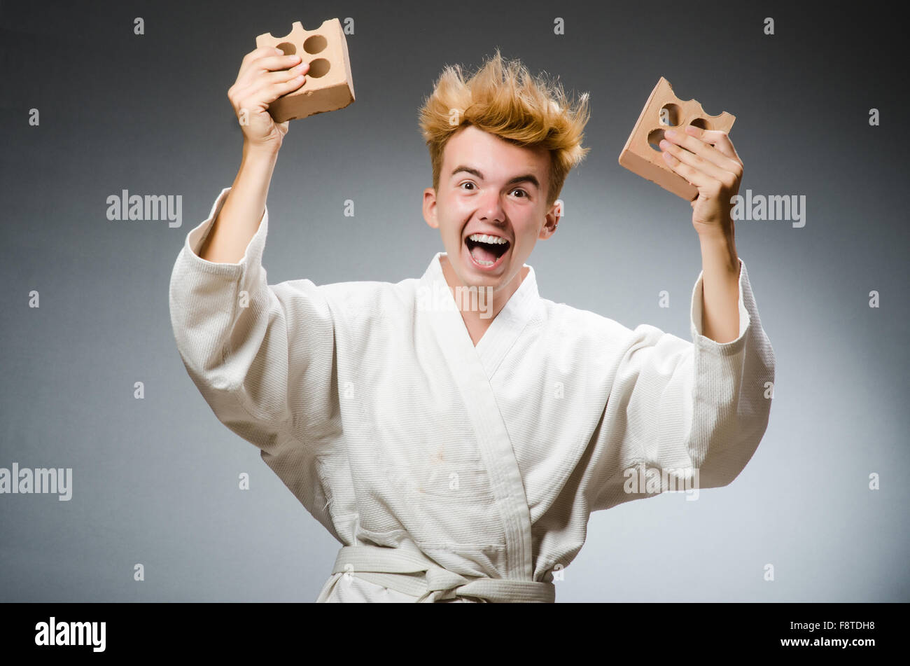 Funny karate fighter with clay brick Stock Photo - Alamy