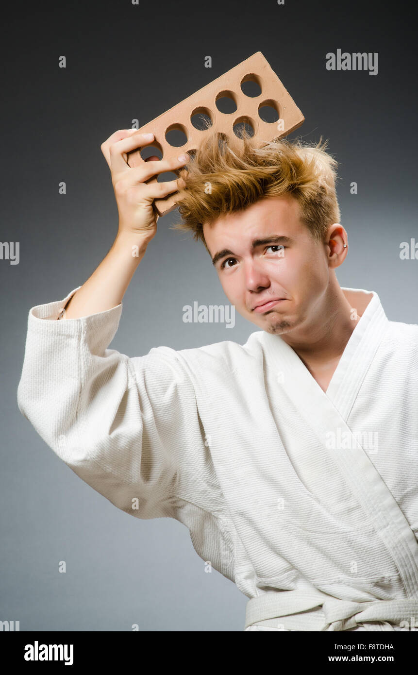 Funny karate fighter with clay brick Stock Photo - Alamy