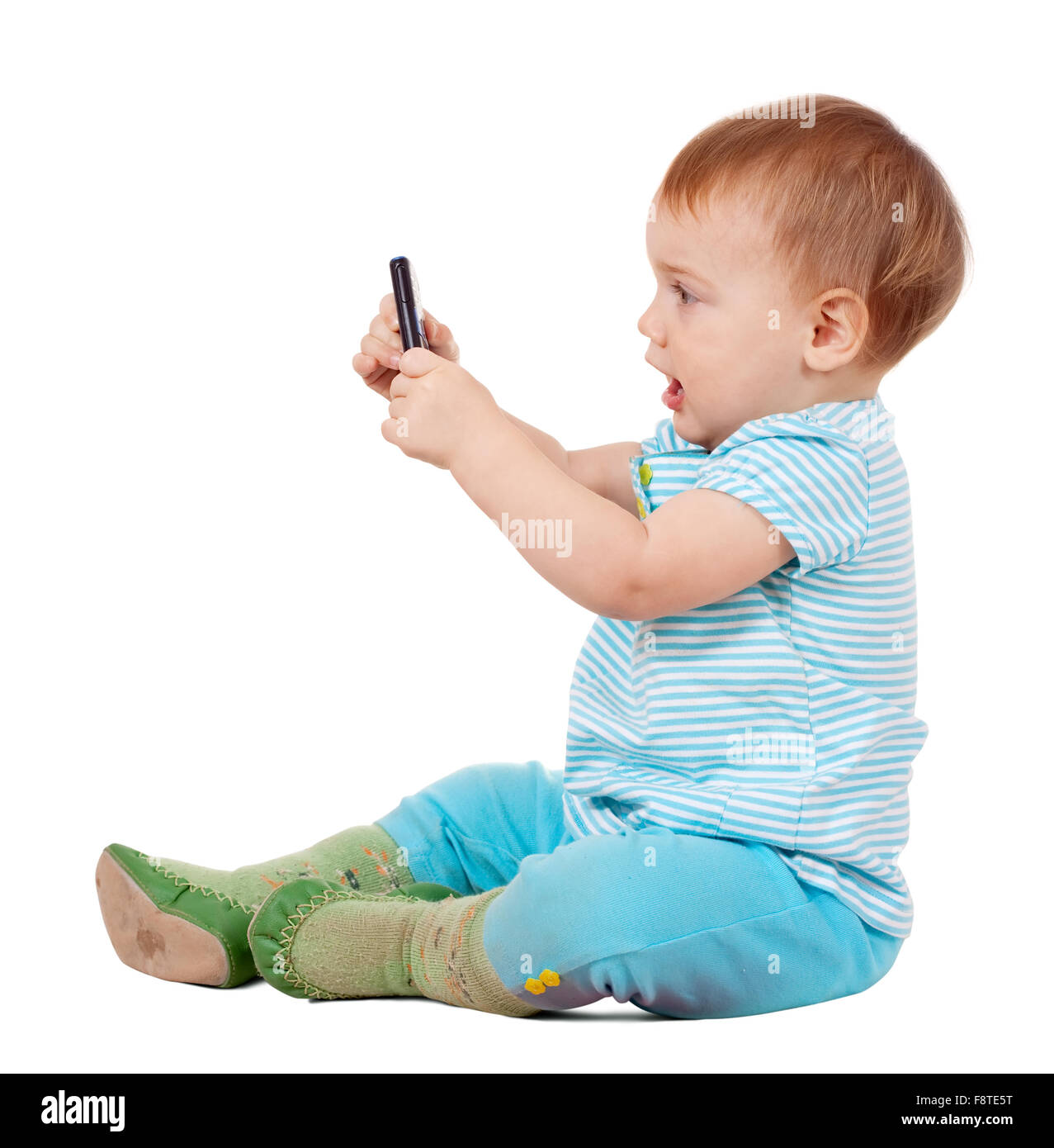 Toddler using mobile phone over white background Stock Photo - Alamy