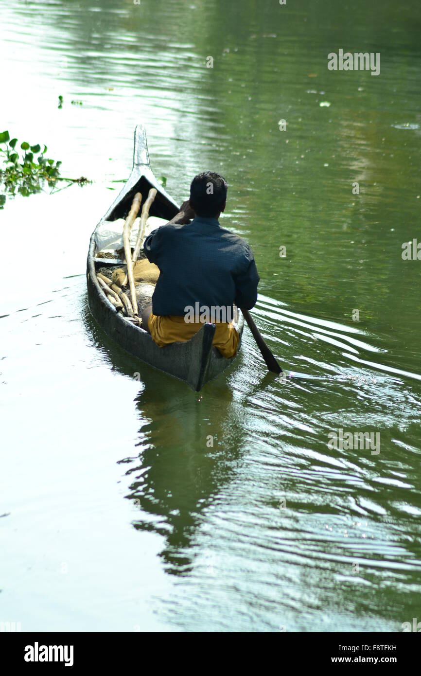 A man riding a small boat Stock Photo - Alamy